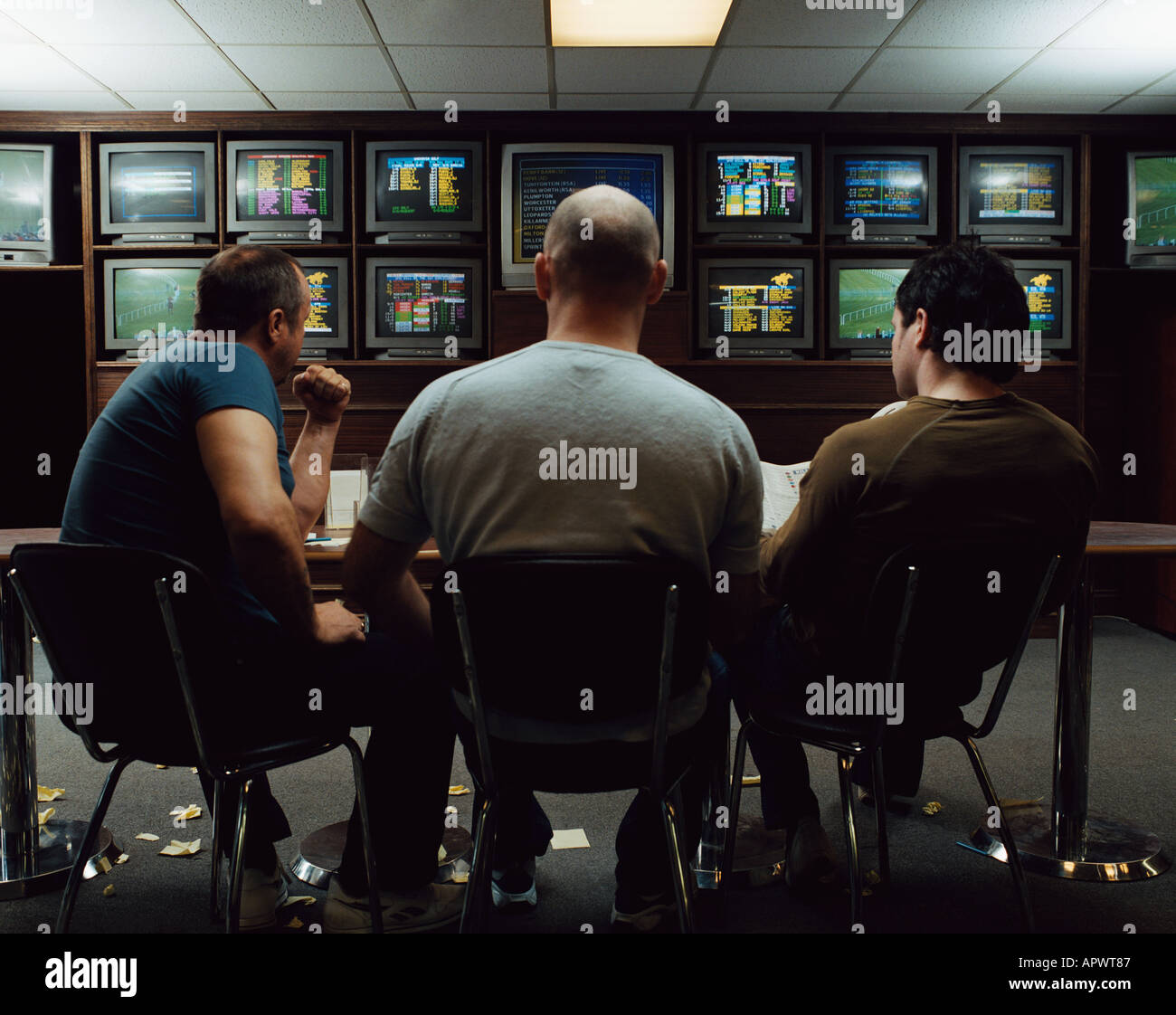 Three men in a betting shop Stock Photo - Alamy
