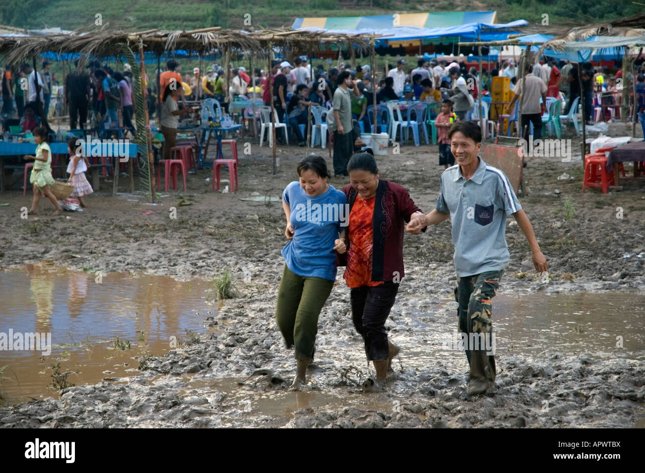 People walking on the mud flats at the sand stupa making party on the ...