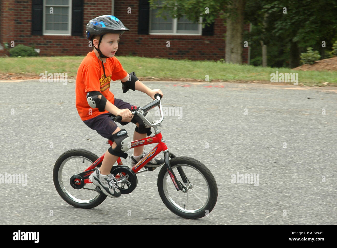 Young rider rides a two wheeler for the first time Stock Photo - Alamy