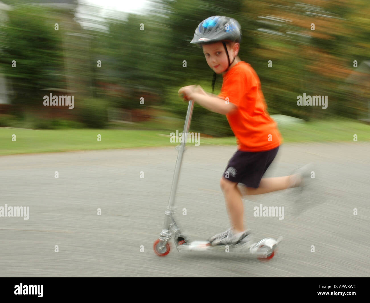 Young boy rides a scooter Stock Photo - Alamy