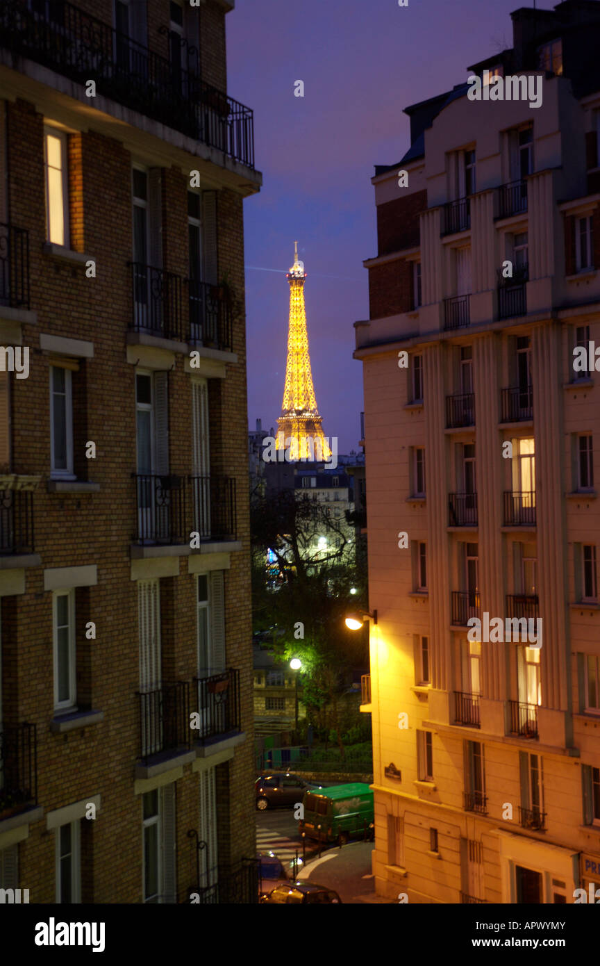 Eiffel Tower standing between two Parisian apartment blocks Stock Photo ...