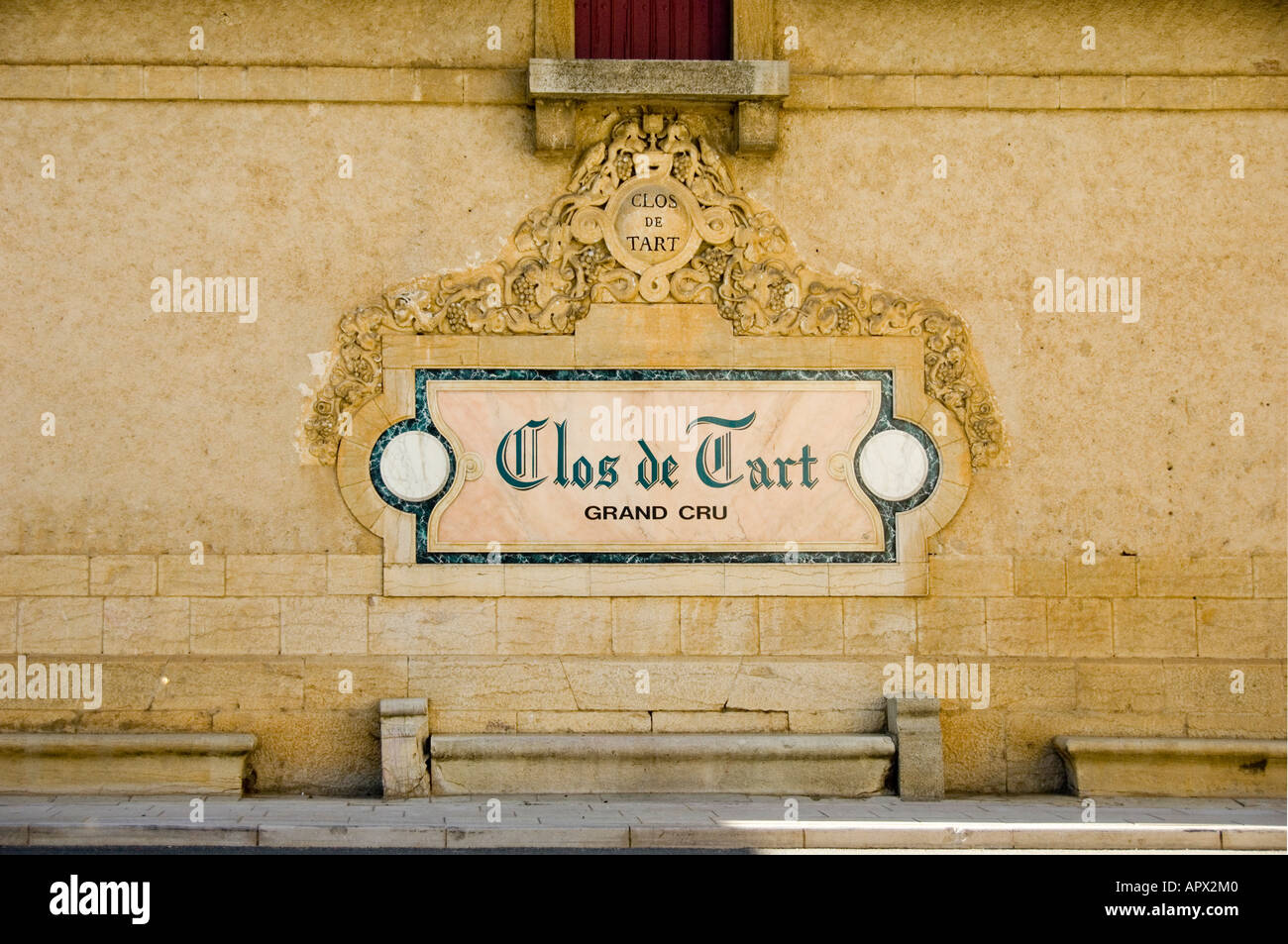 The elaborate Clos de Tart grand cru sign on winery building wall in ...