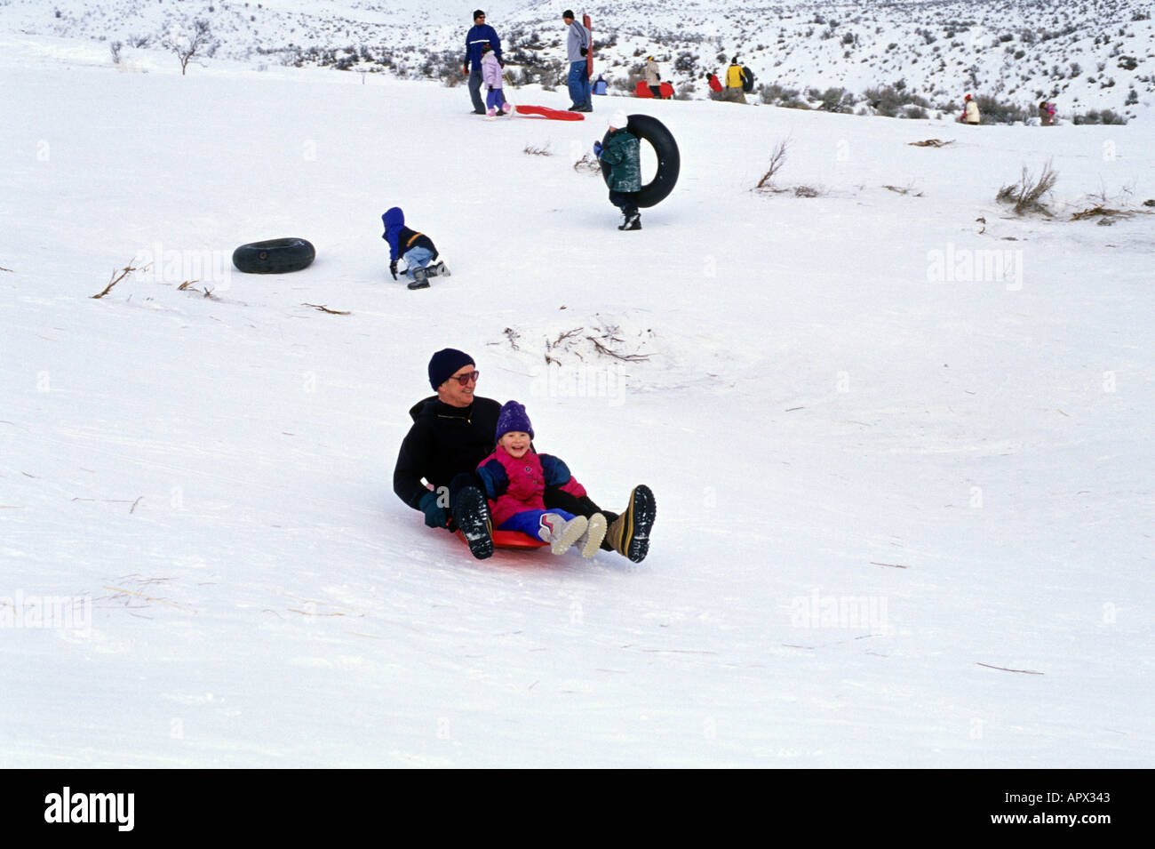 Grandfather sledding with his granddaughter in the snow Stock Photo - Alamy
