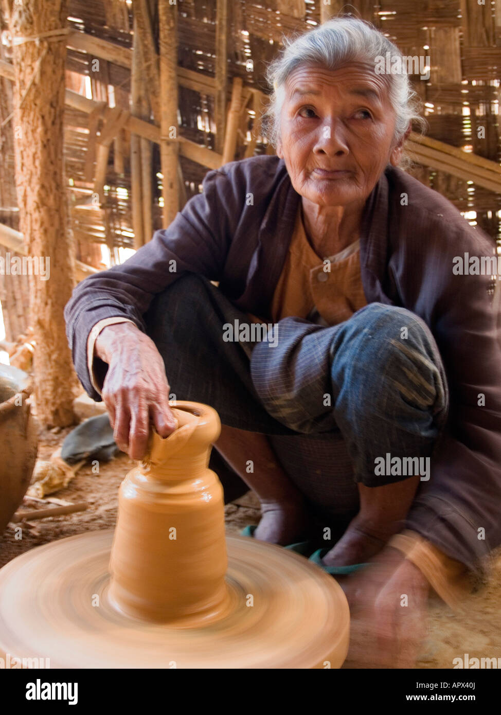 Burmese woman making pottery at Inle Lake in Myanmar Stock Photo - Alamy