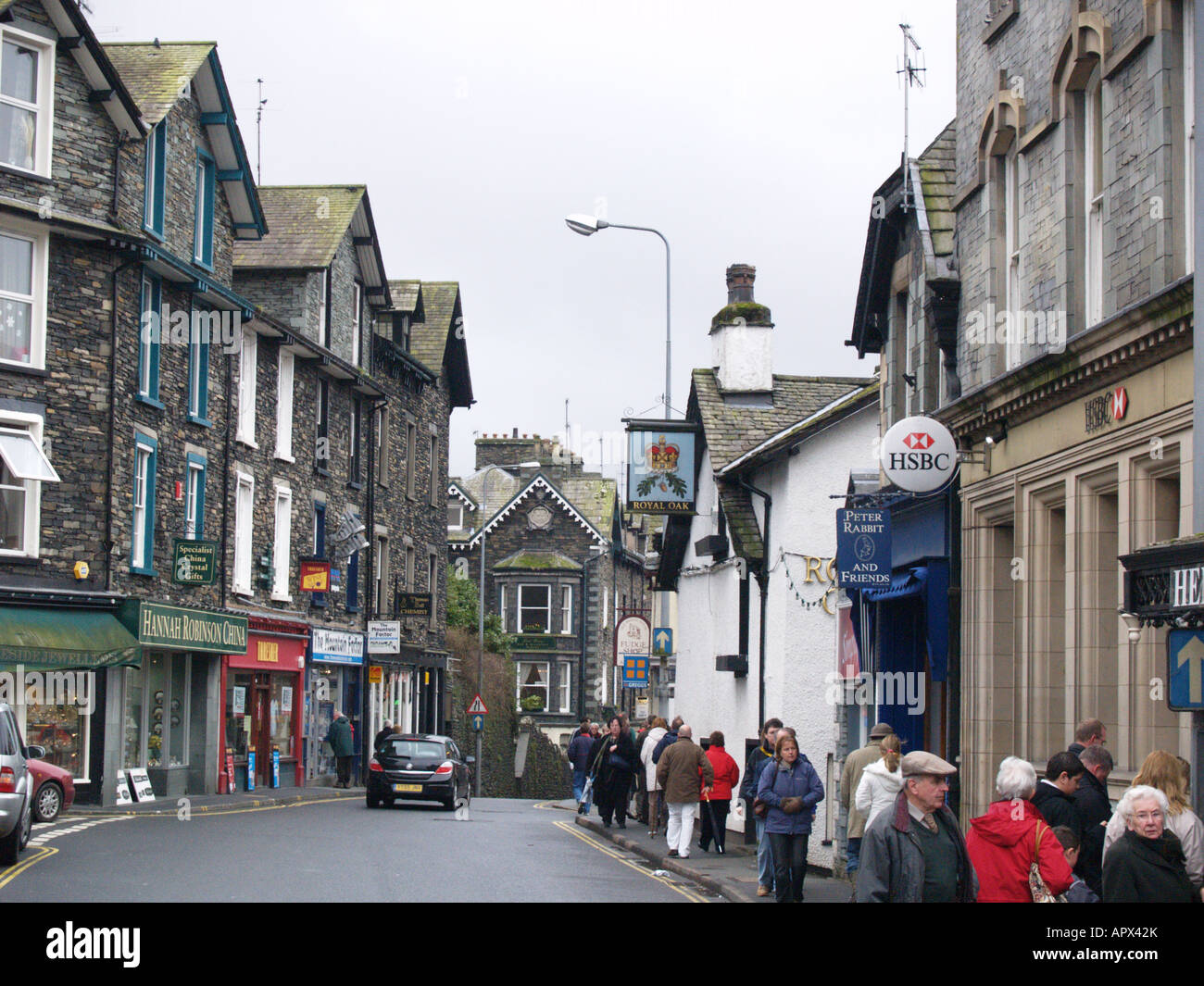 visitors ambleside high st shops street road cars Stock Photo - Alamy