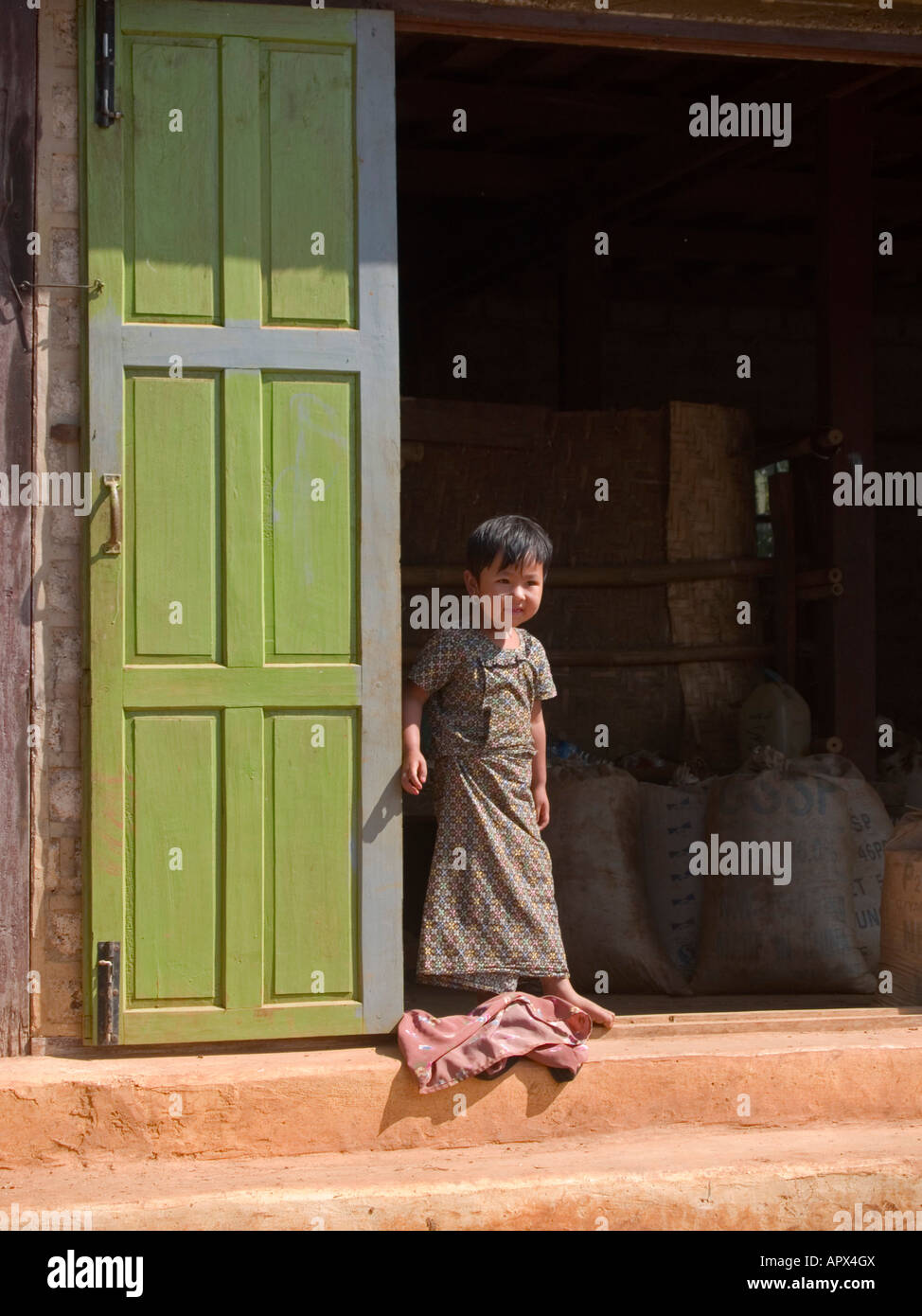 Danu minority girl stands in her doorway near Inle Lake in Myanmar ...