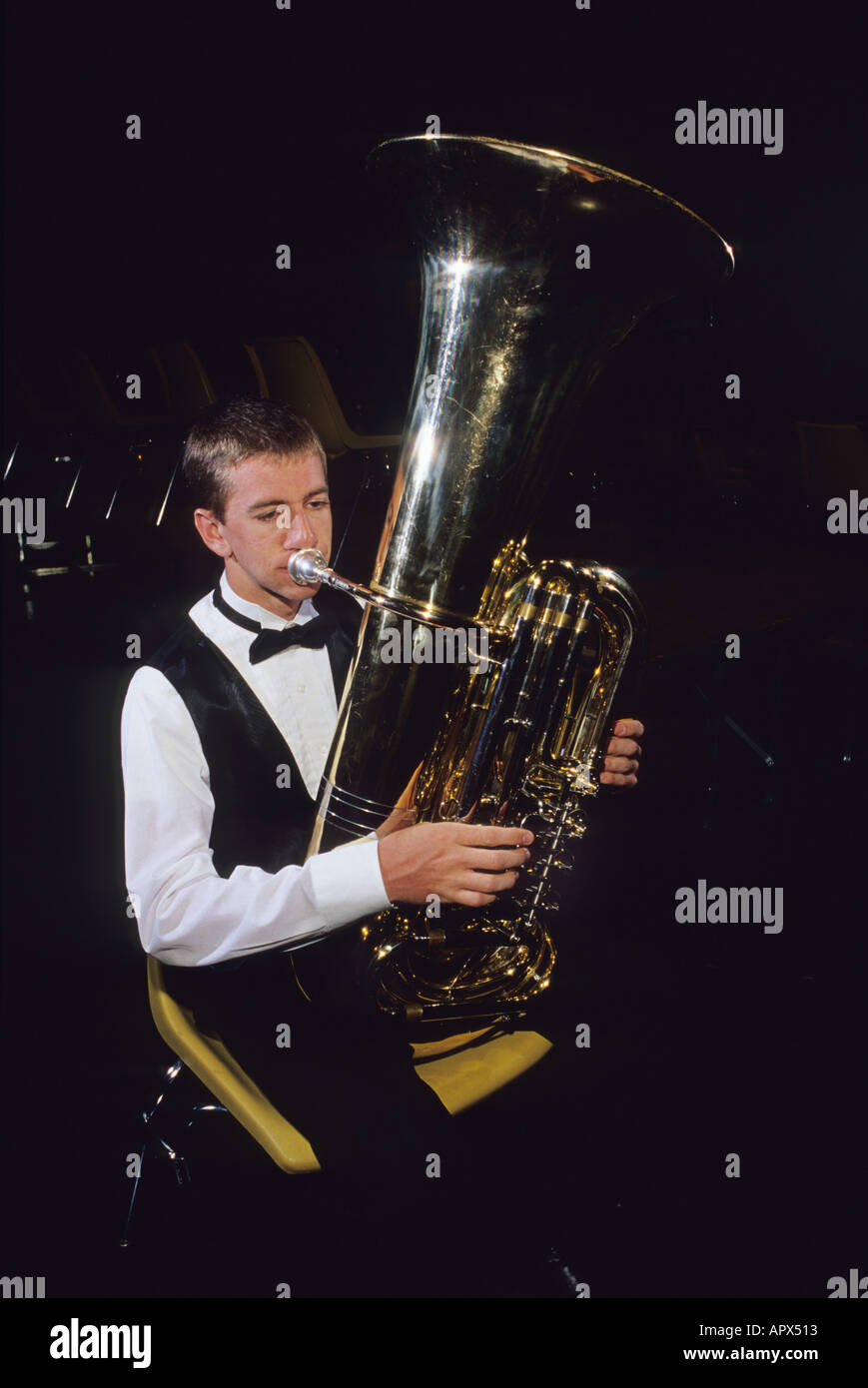 A teen playing an upright tuba Stock Photo - Alamy