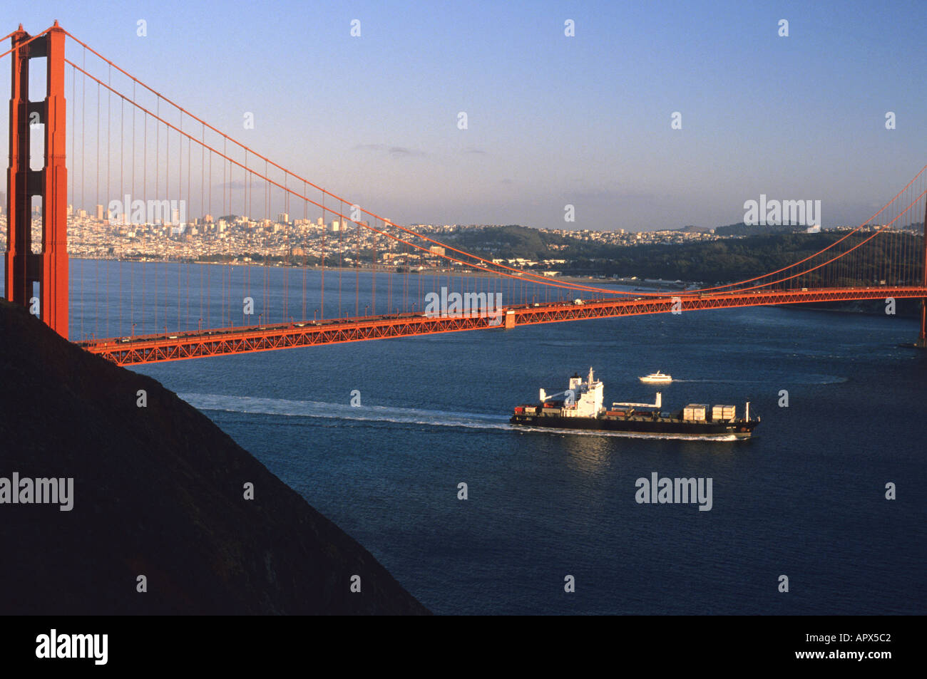 A cargo ship passes under the Golden Gate Bridge in San Francisco ...