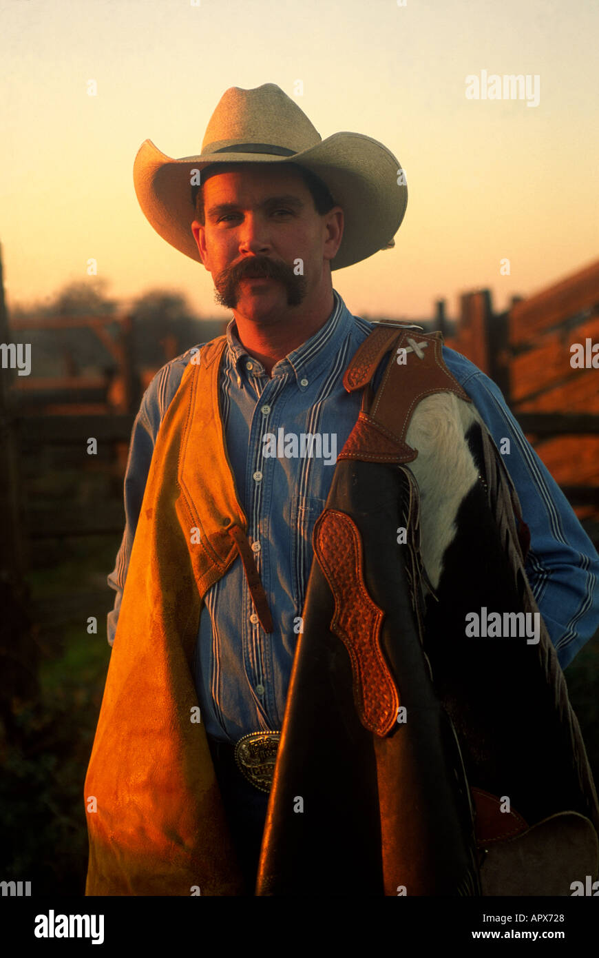 A cowboy stops for a portrait while working on a cattle ranch Stock ...