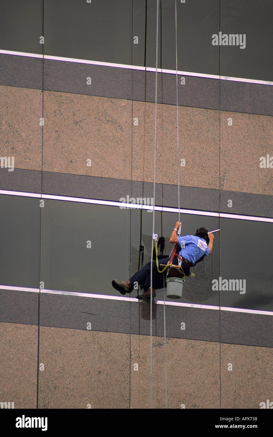 A man washing the windows of a high rise building Stock Photo - Alamy