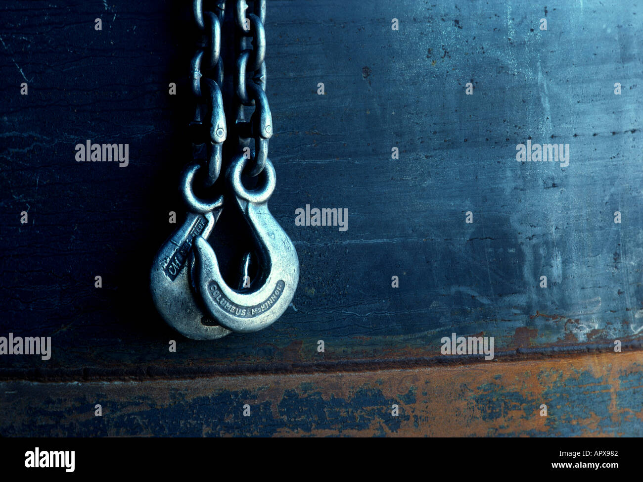 A close up of a giant hook and chain hanging down the side of a ...