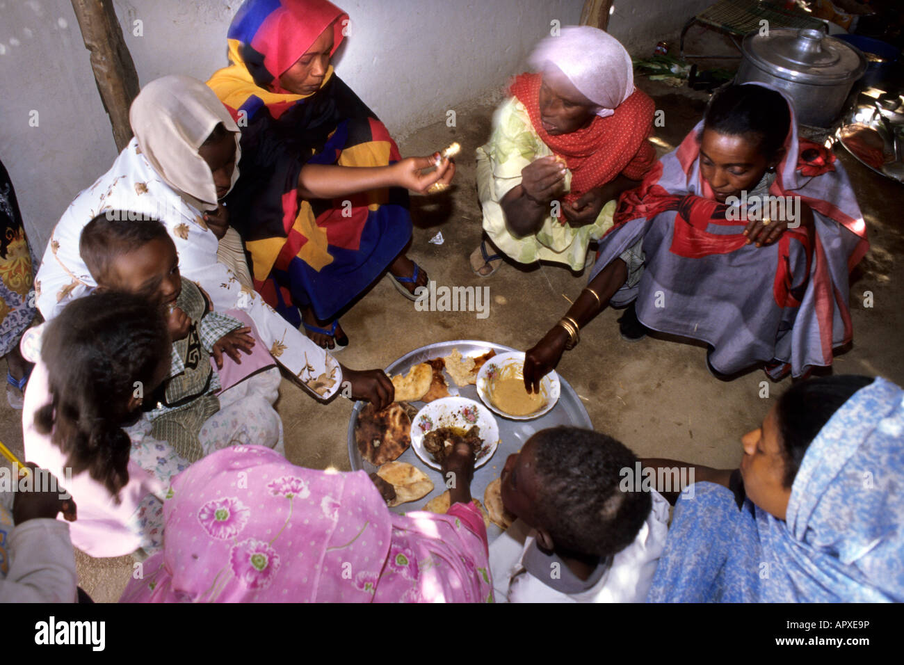 Nubian women and children share lunch inside their kitchen Stock Photo ...