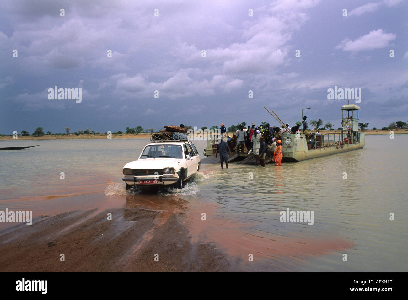 Ferry on the Niger river with dilapidated vehicle driving through ...