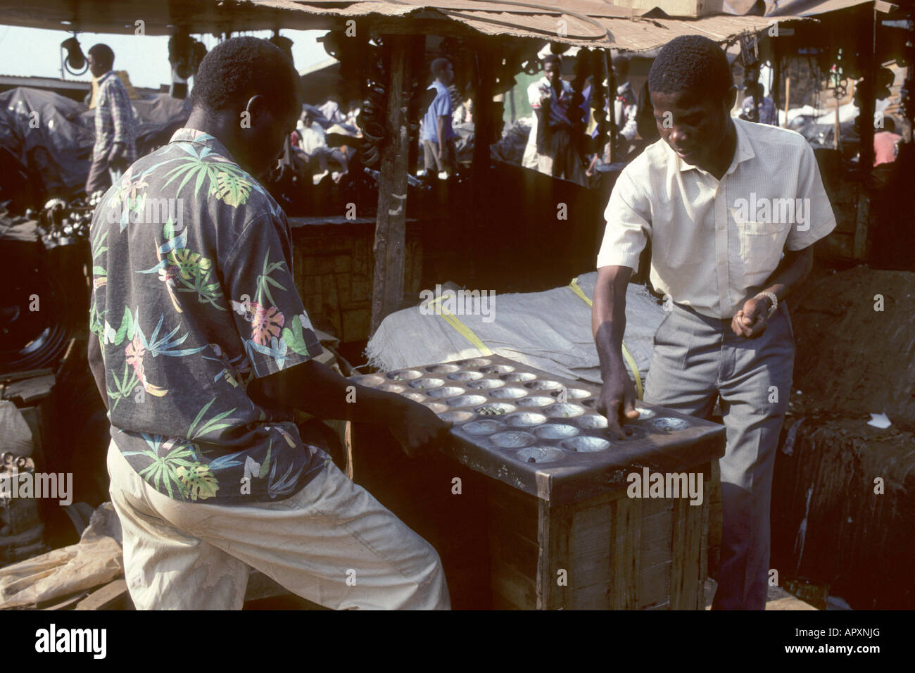 Two men playing a traditional game called bao at the Lilongwe market ...