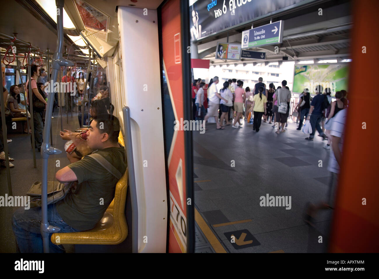 commuters and tourists disembark a Sukhumvit line Skytrain, in Bangkok ...