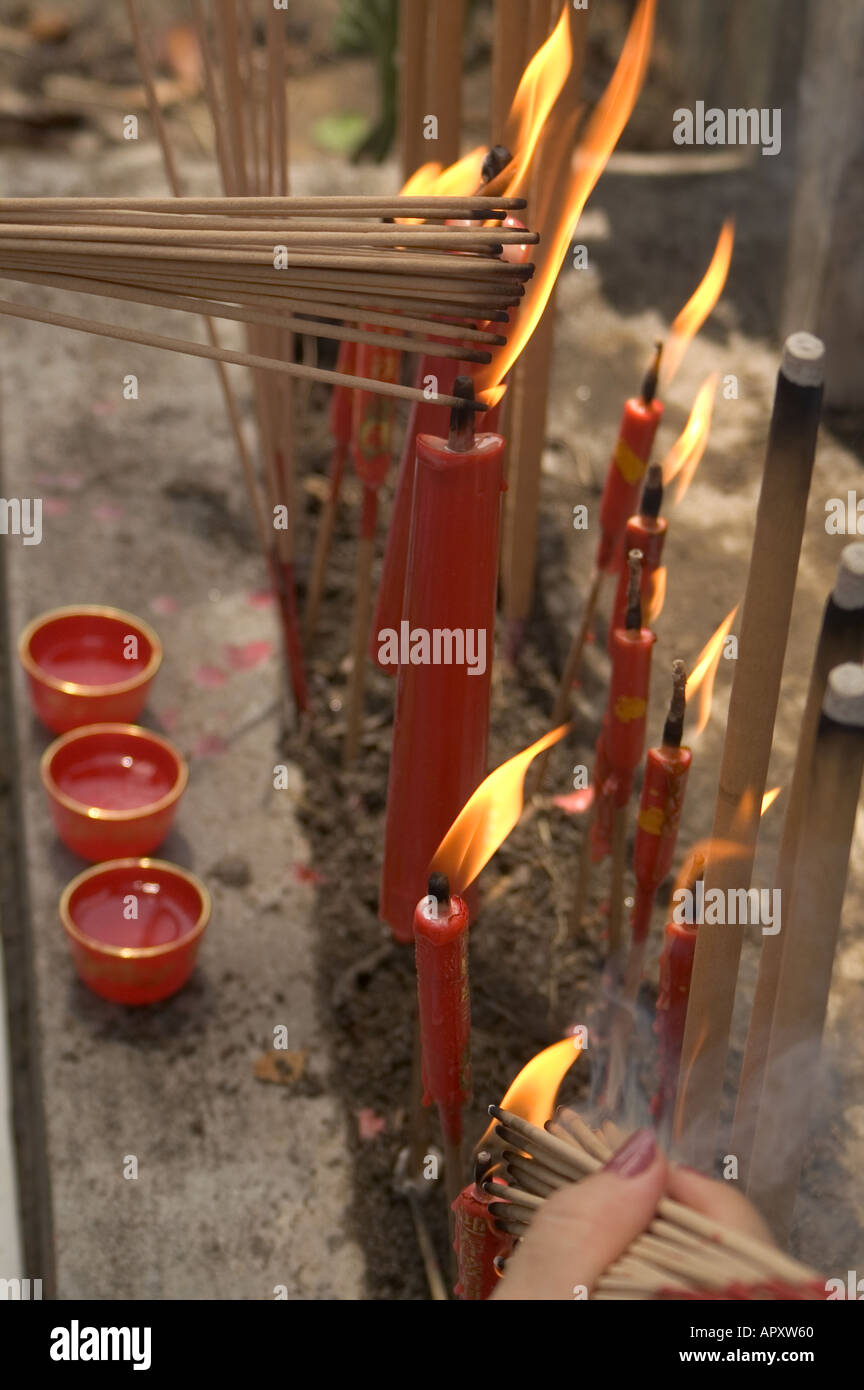 Burning josticks at ancestor's grave during the Qing Ming Festival ...