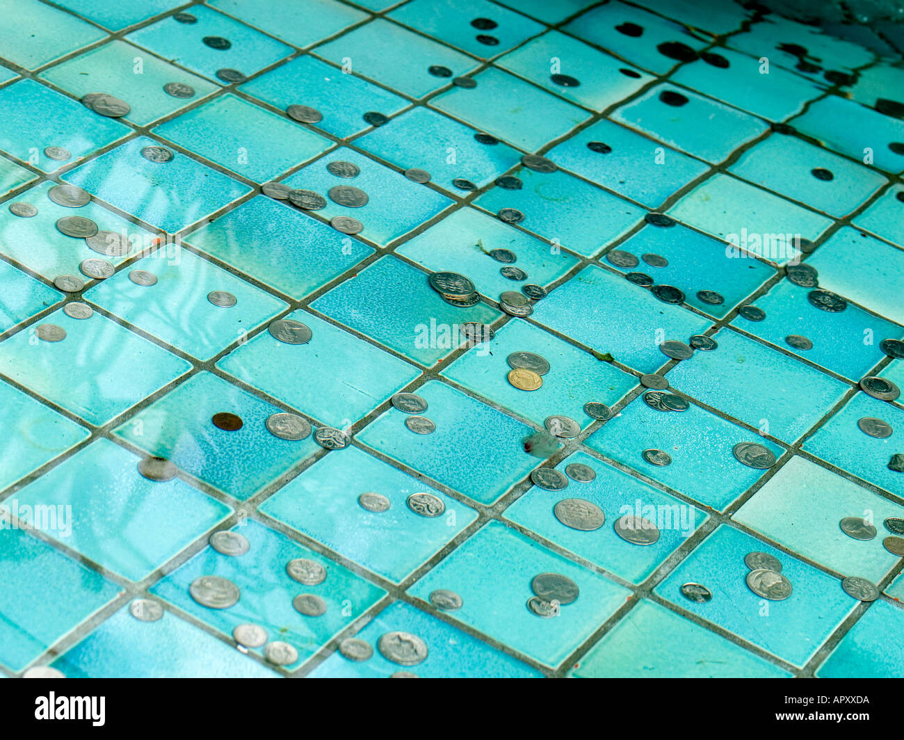 coins of money scattered in a wishing well pool Stock Photo - Alamy