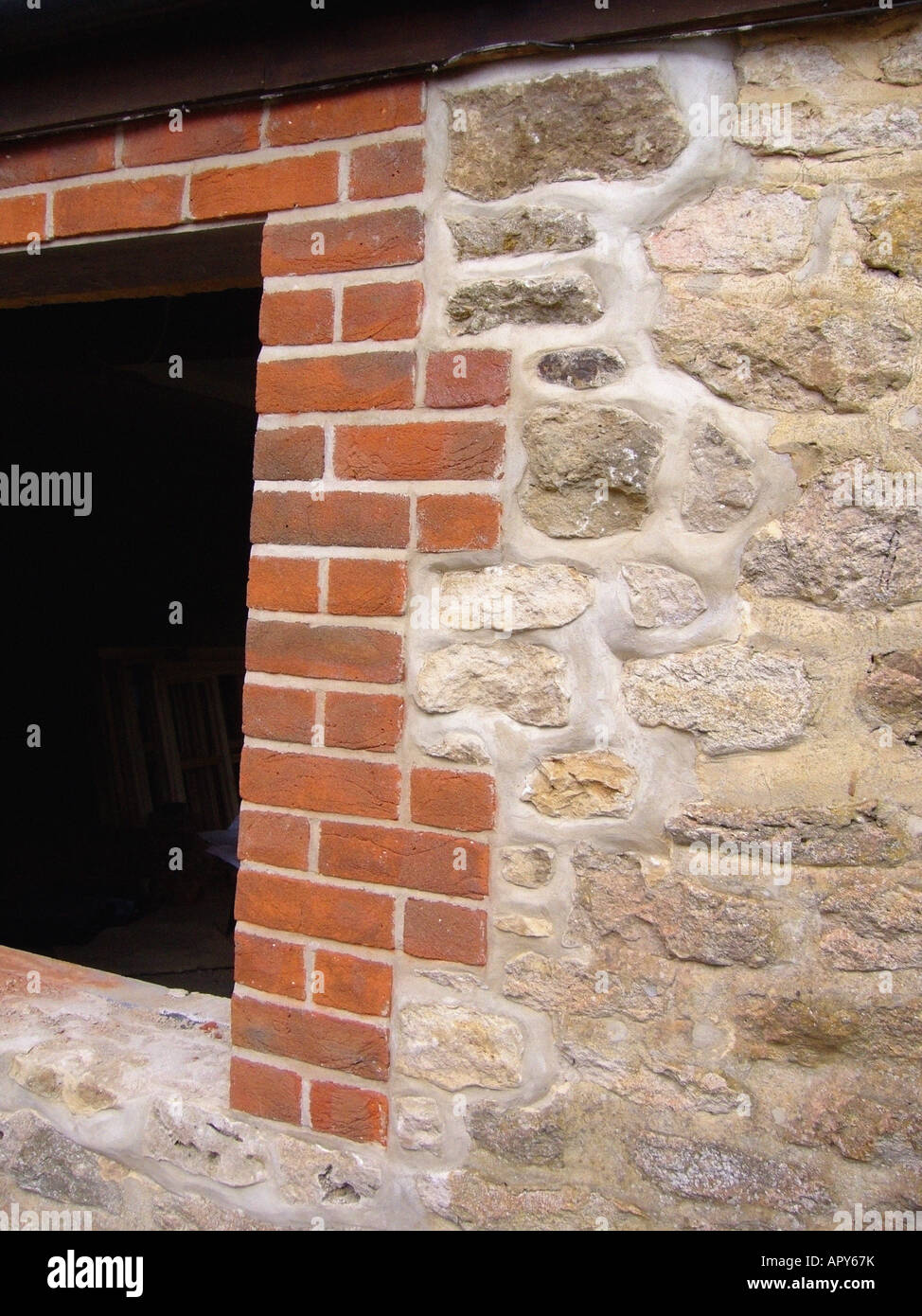 brickwork toothed into stone wall Stock Photo - Alamy