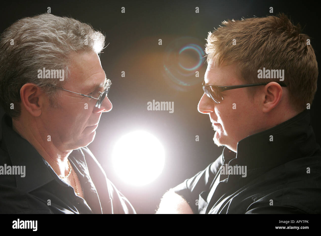 2 males men in studio looking at each other Stock Photo - Alamy