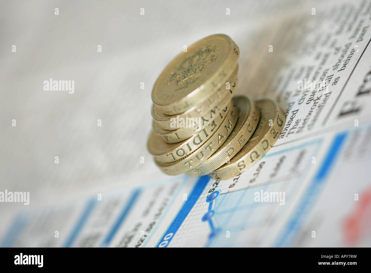 Stack of GBP one pound coins on financial newspaper graph Stock Photo ...