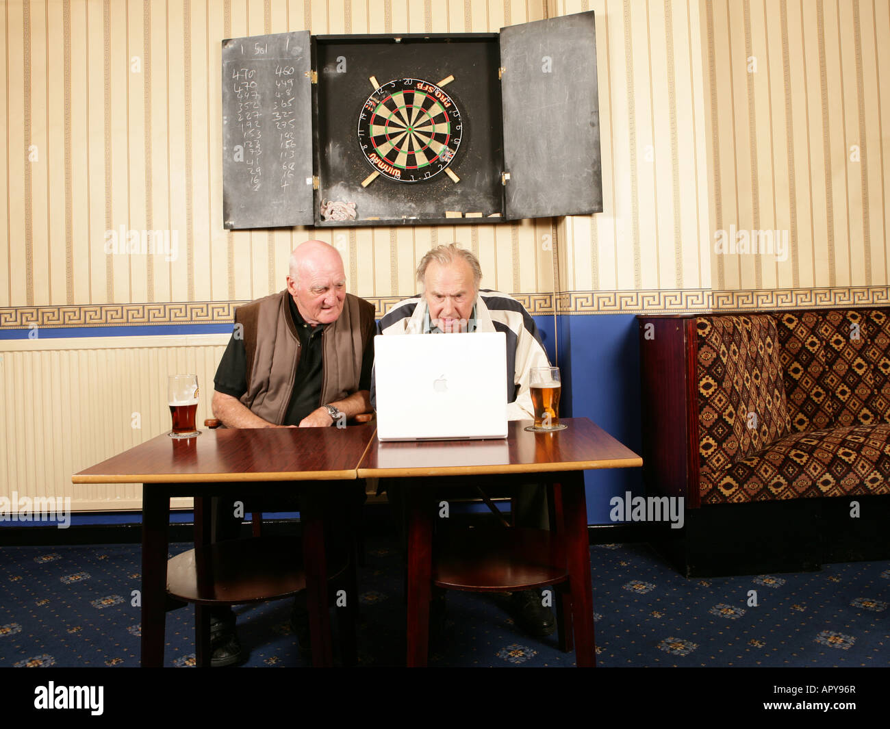 Old people men using new technology in local working mans club pub ...