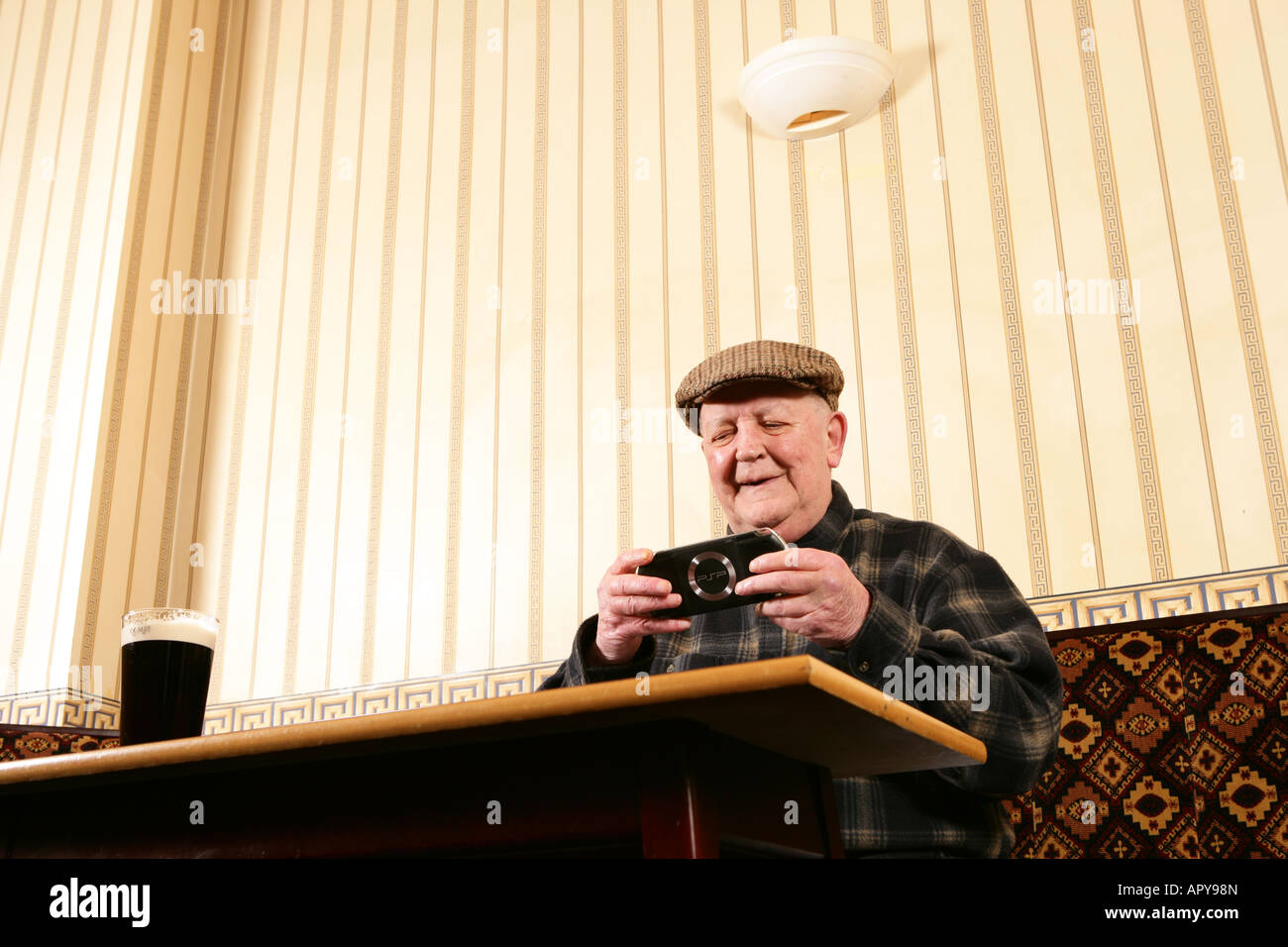 Old people men using new technology in local working mans club pub ...