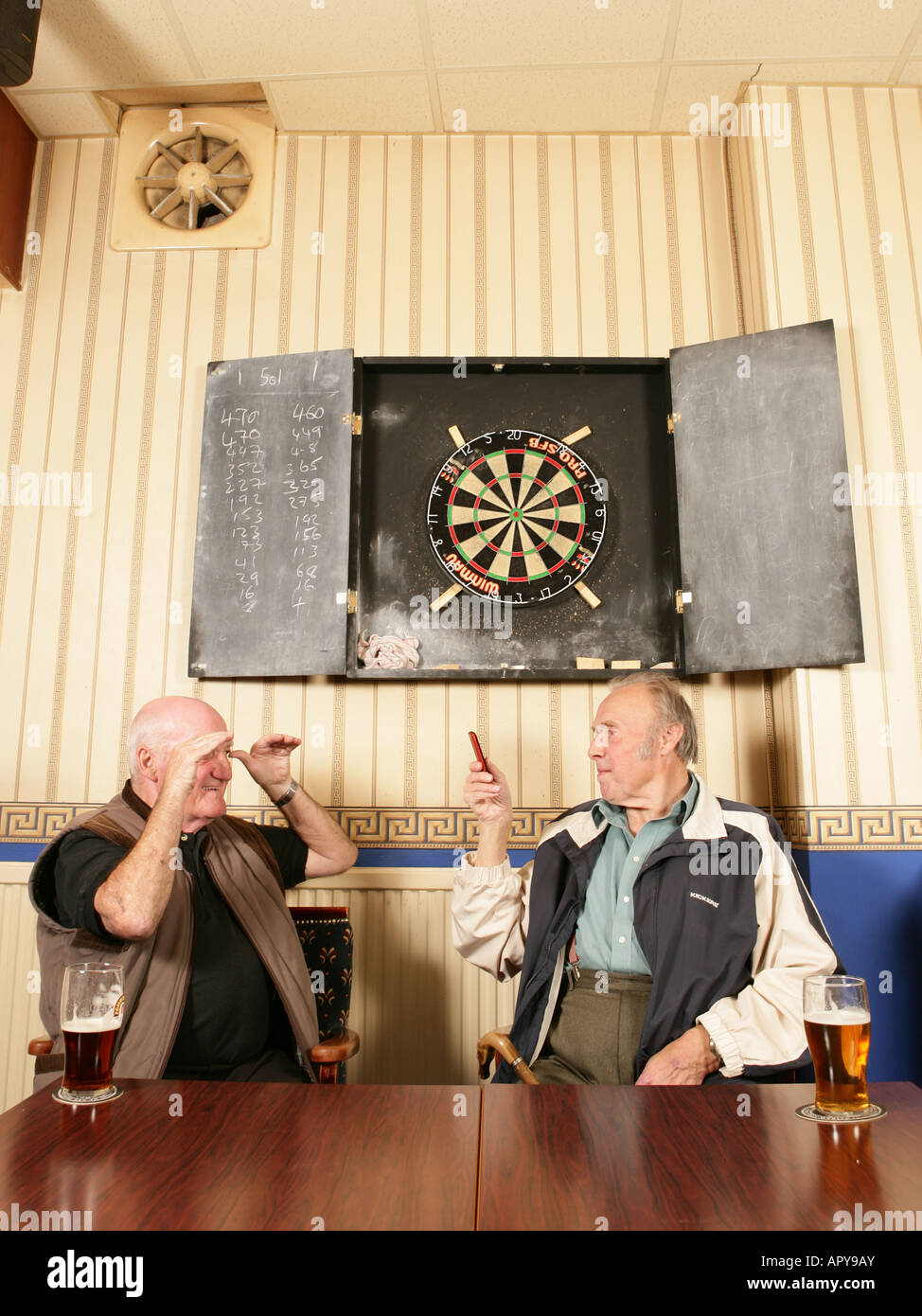 Old people men using new technology in local working mans club pub with ...