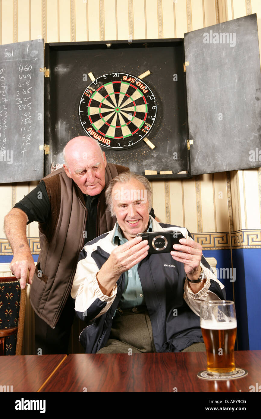 Old people men using new technology in local working mans club pub ...