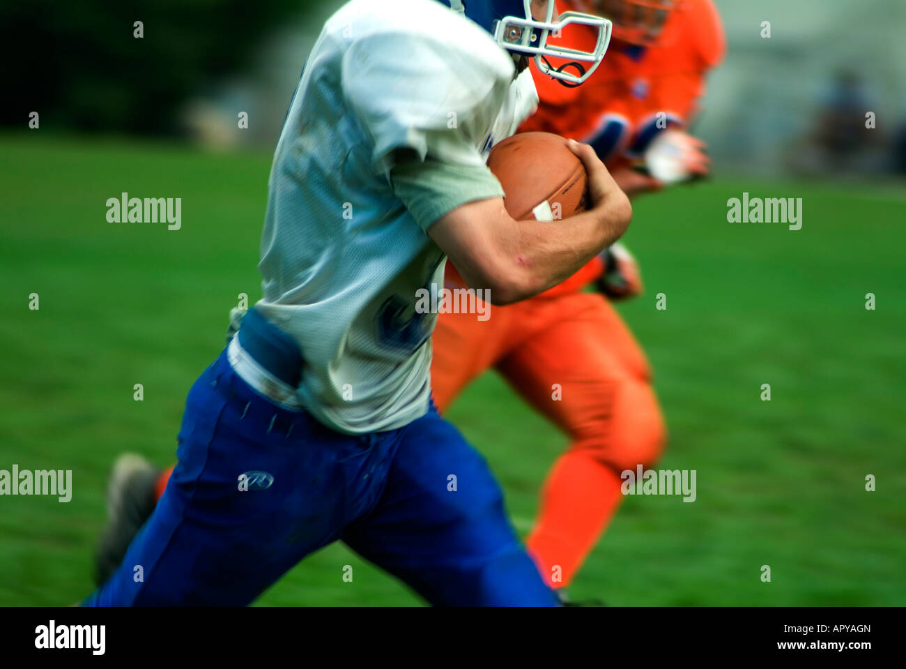 American football players playing football Stock Photo - Alamy