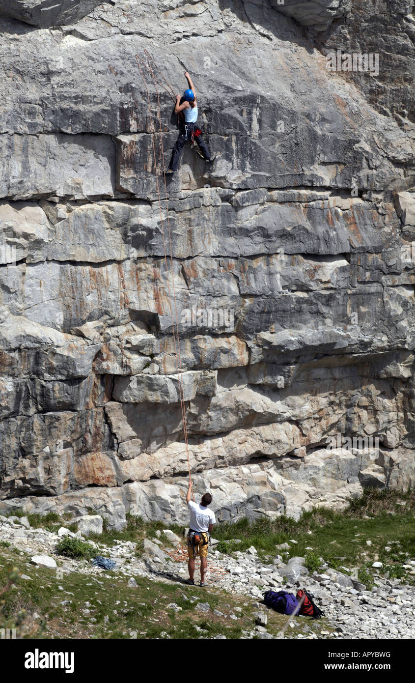 Climbers negotiating the rock faces near Dancing Ledge, Isle of Purbeck ...