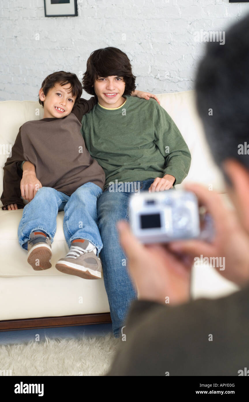 Hispanic brothers having photograph taken Stock Photo - Alamy