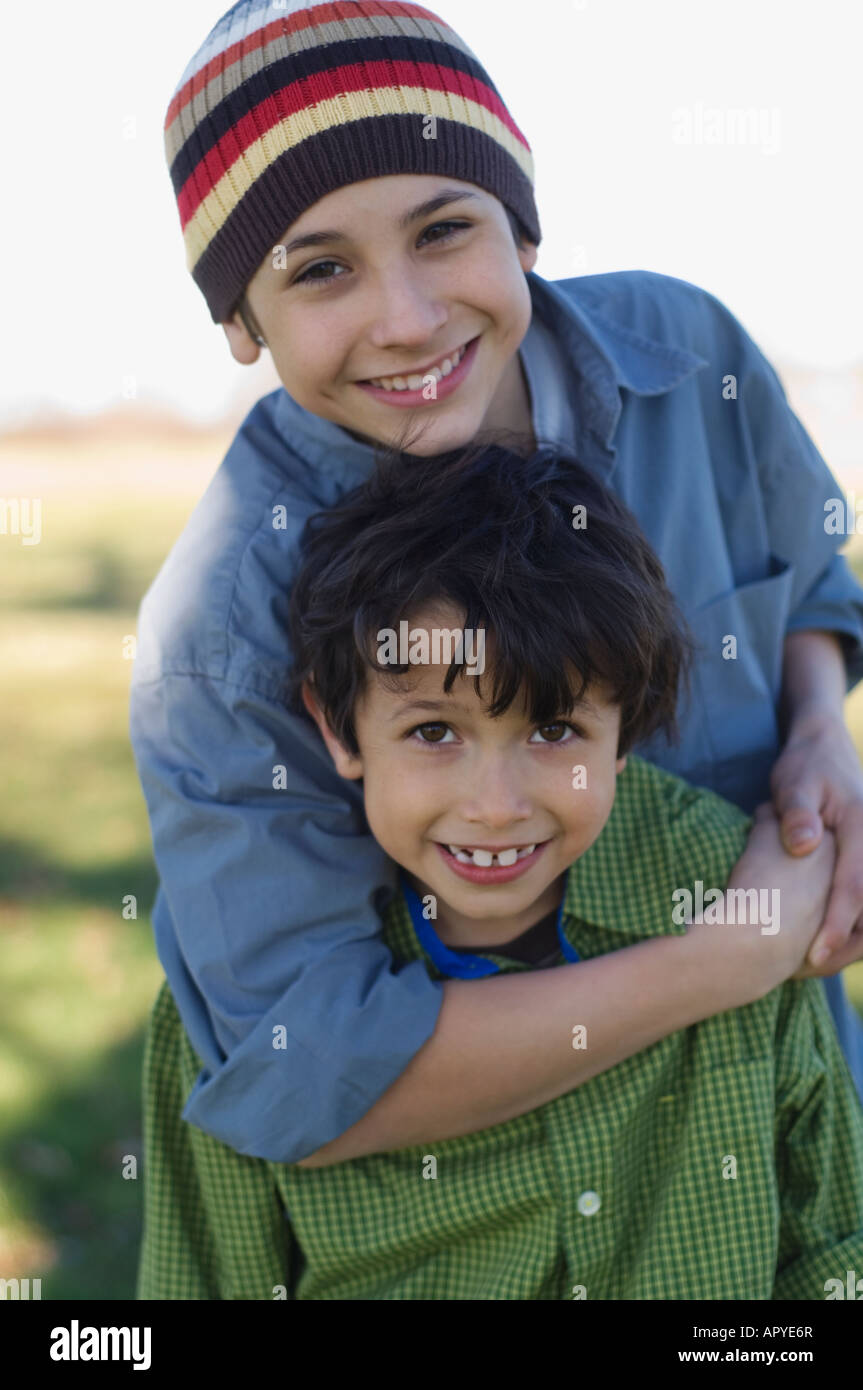 Hispanic brothers hugging outdoors Stock Photo - Alamy