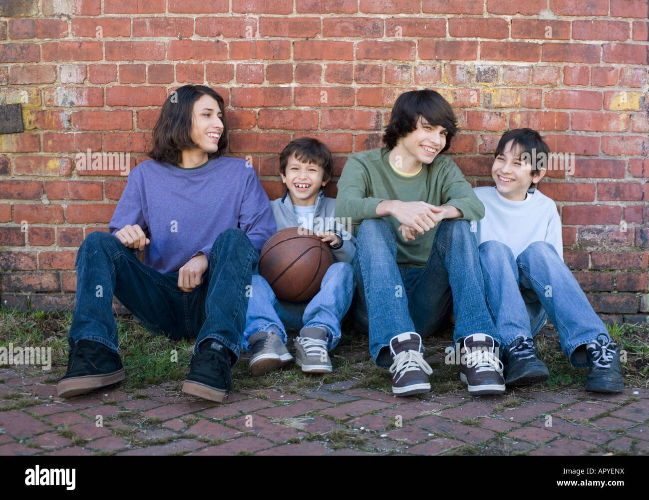 Hispanic brothers sitting with basketball Stock Photo - Alamy