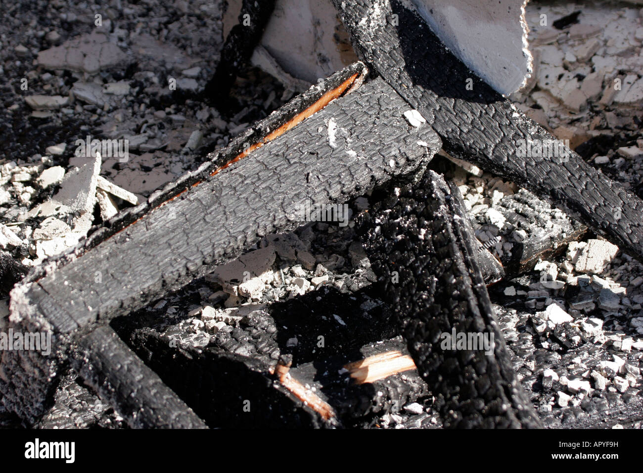 Charred debris from a structure fire including burnt pieces of wood ...
