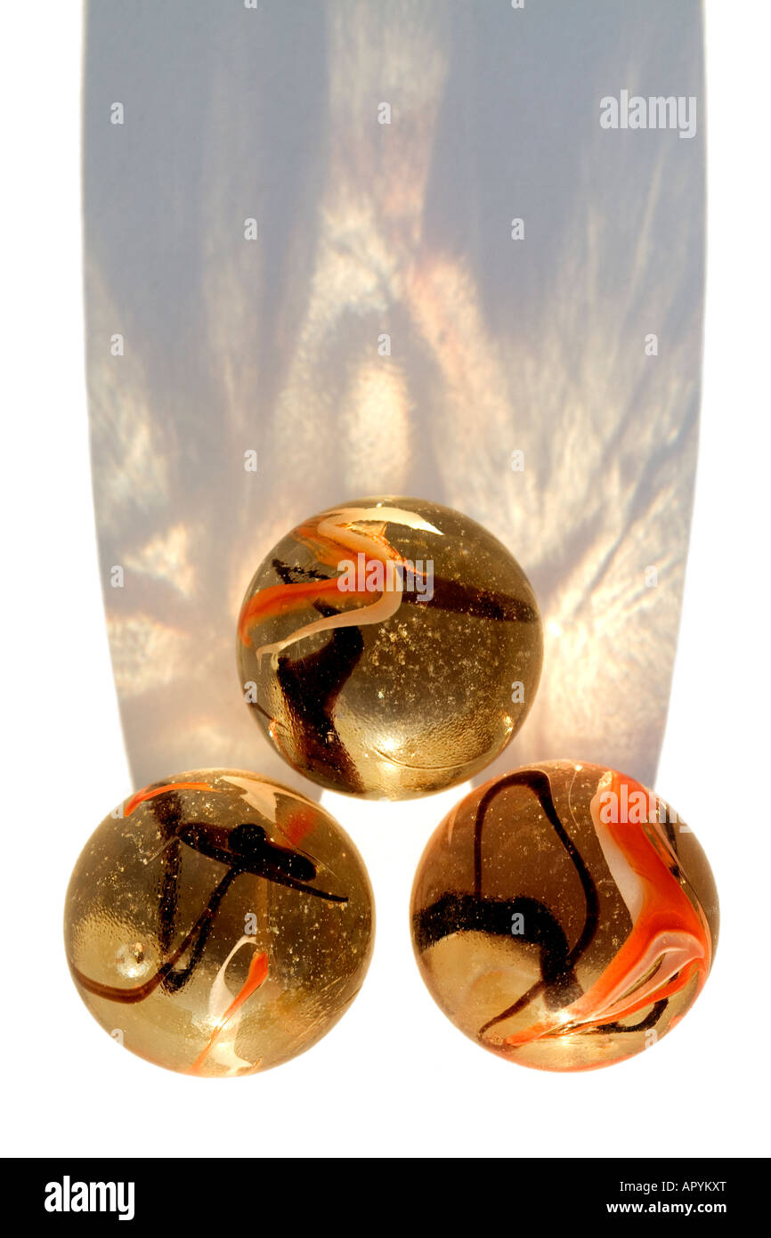 An unusual image of three colorful glass marbles and their interesting ...