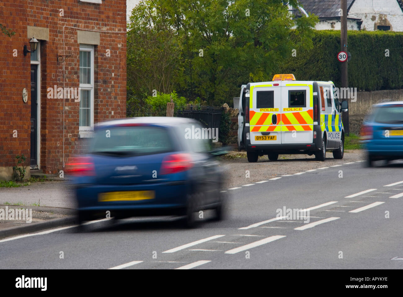 Blue saloon car speeding past 30 mph police mobile speed trap traffic ...