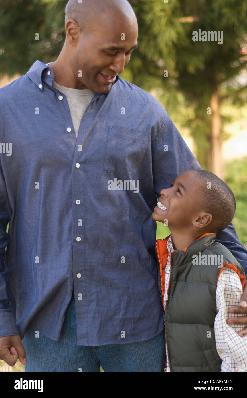 African father and son smiling at each other Stock Photo - Alamy