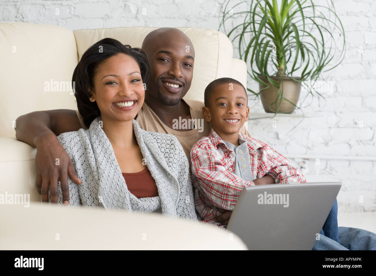 African family hugging on sofa Stock Photo - Alamy