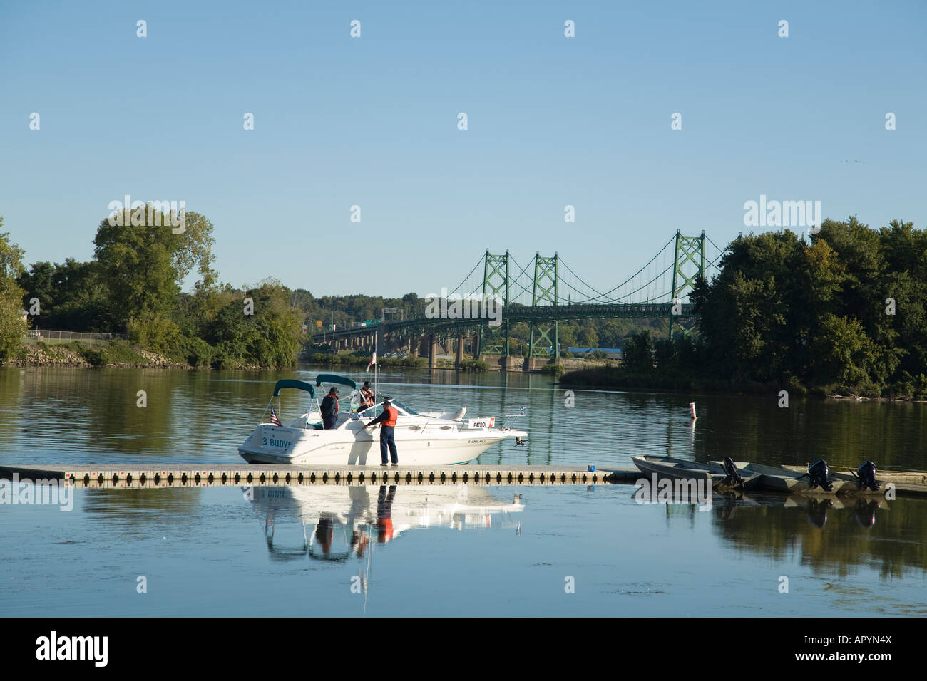 ILLINOIS Moline Man standing next to motorboat dock in Mississippi ...