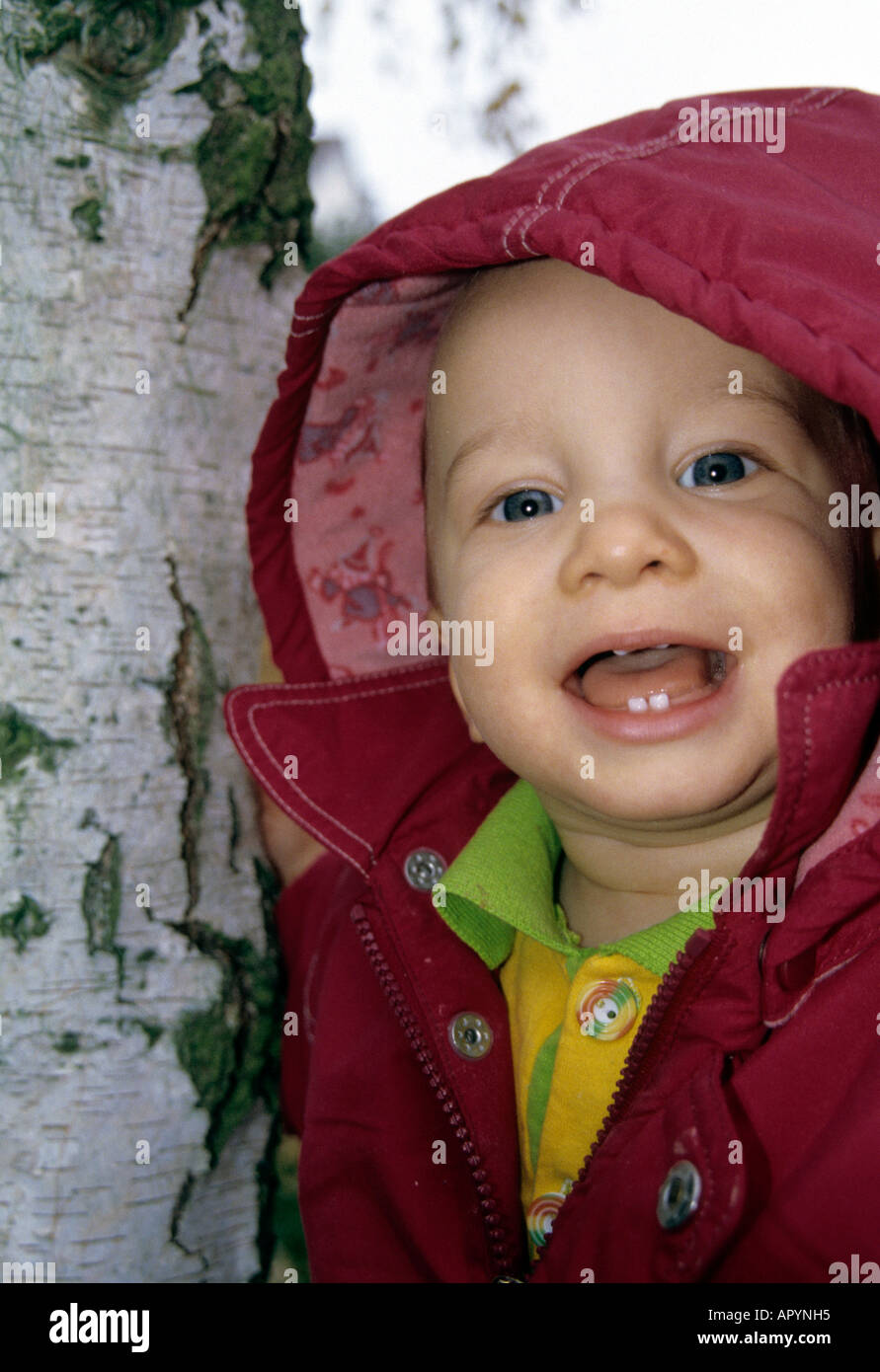 Boy one years old happy two teeth next to birch tree Stock Photo - Alamy