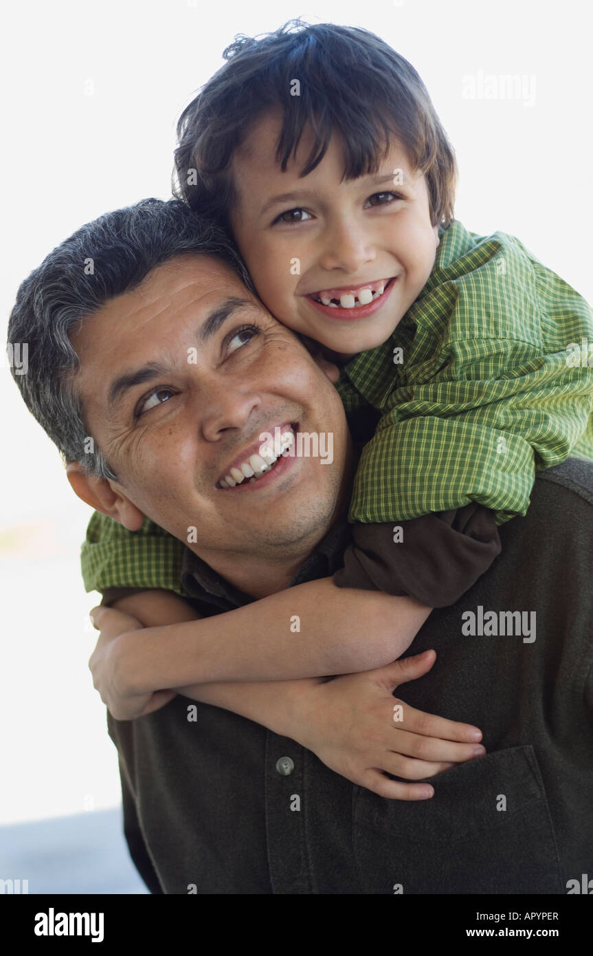 Hispanic boy hugging father Stock Photo - Alamy