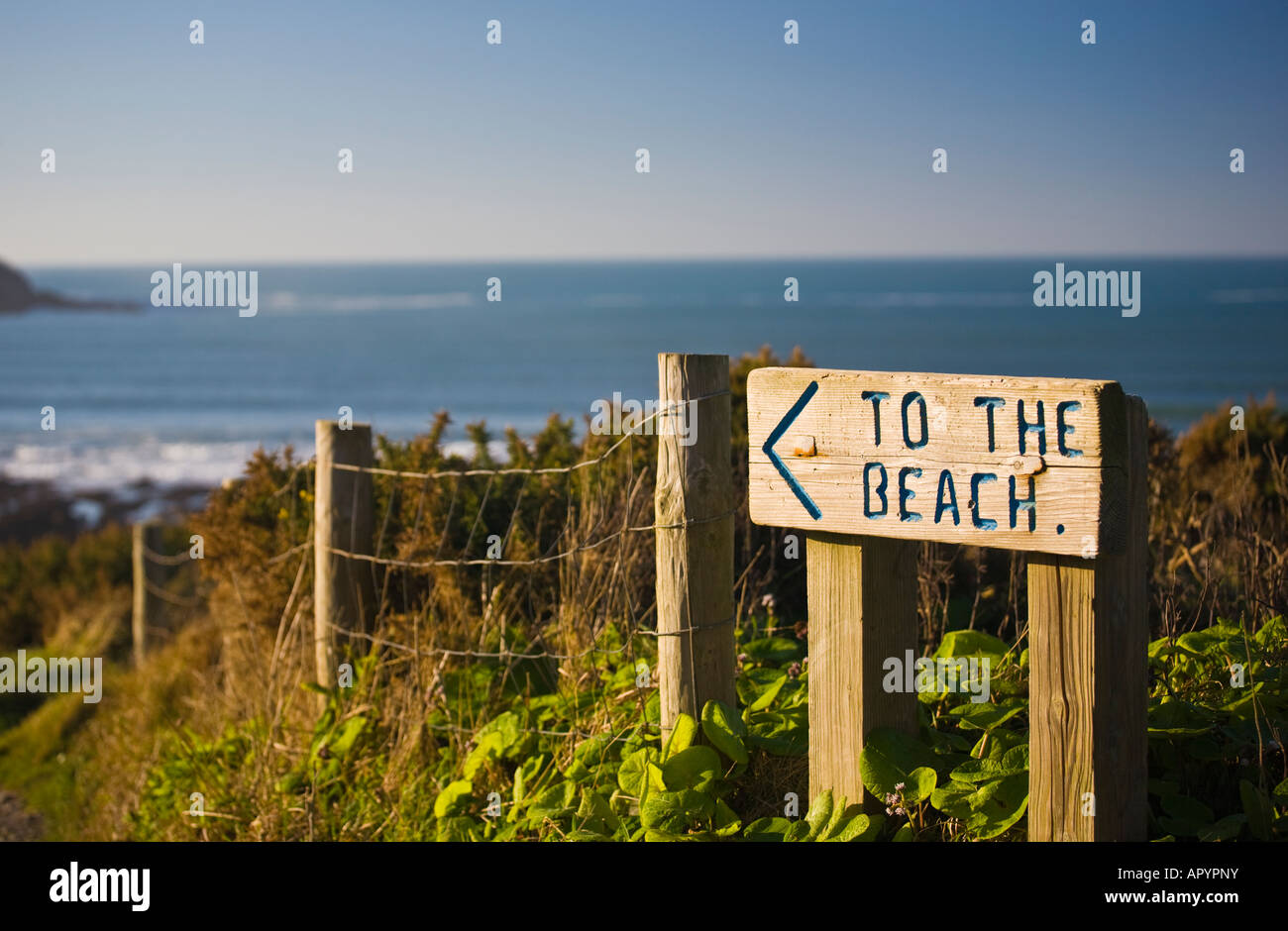 Sign on the coast path near Polzeath showing the direction of a beach ...