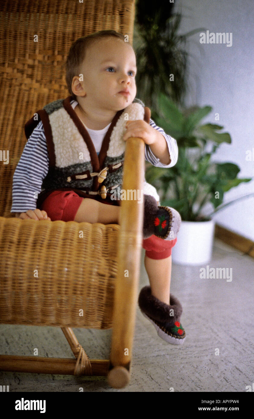 Boy two years old in swinging rocking chair armchair Stock Photo - Alamy