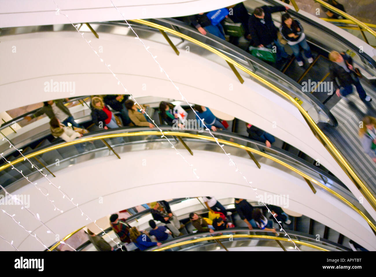 Circular escalator and Shoppers Stock Photo - Alamy