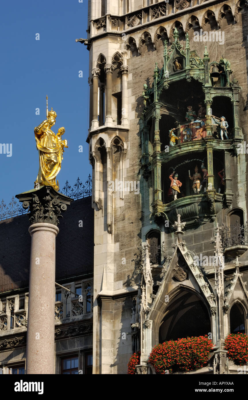 Statue of the Virgin Mary with the glockenspiel figures on the tower of ...