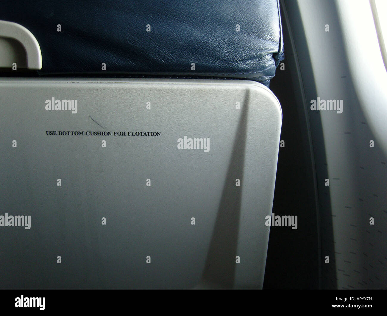 The tray table is stowed and the seat back is in the upright position ...