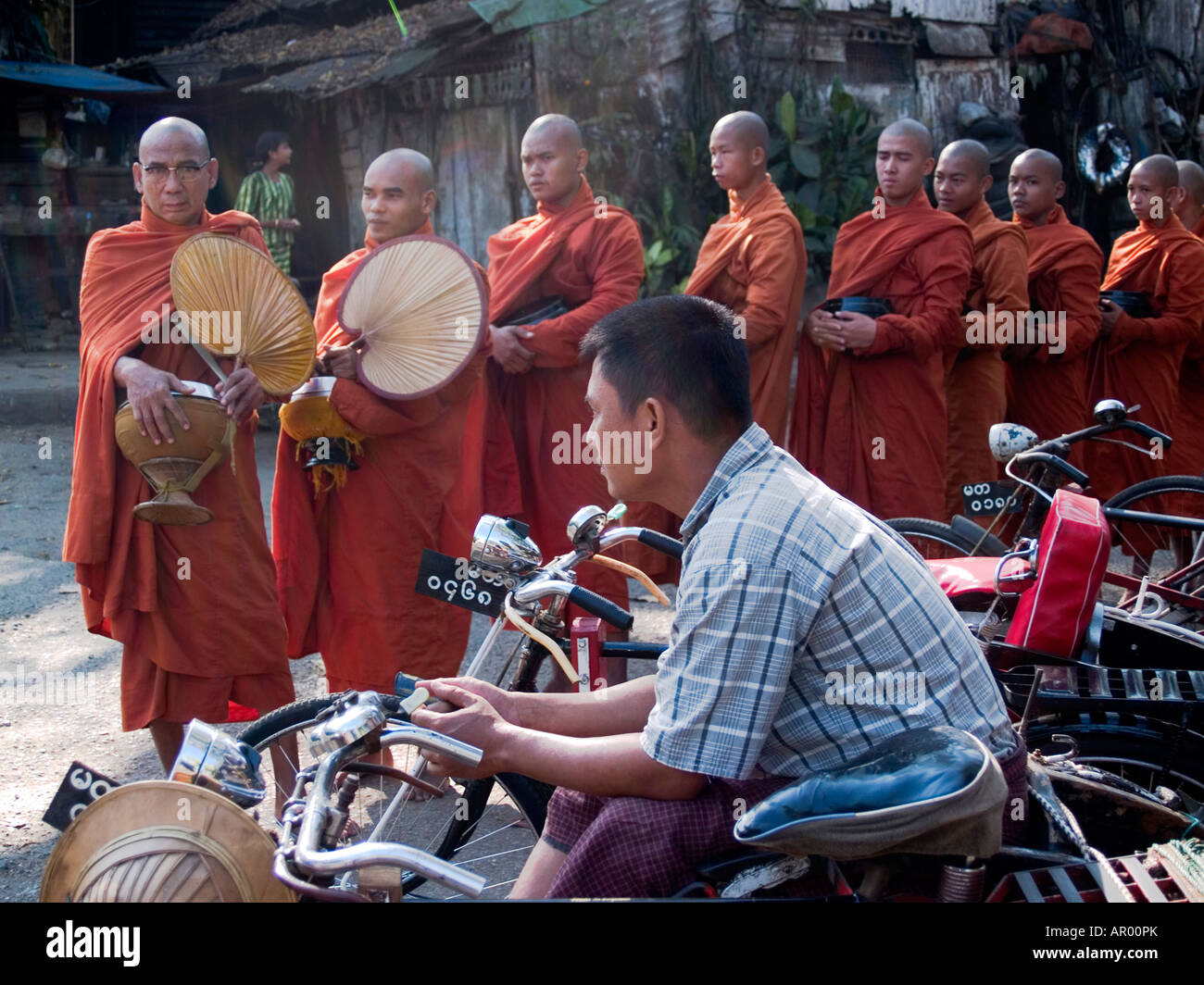 single file lineup of monks for morning alms in Burma Stock Photo - Alamy