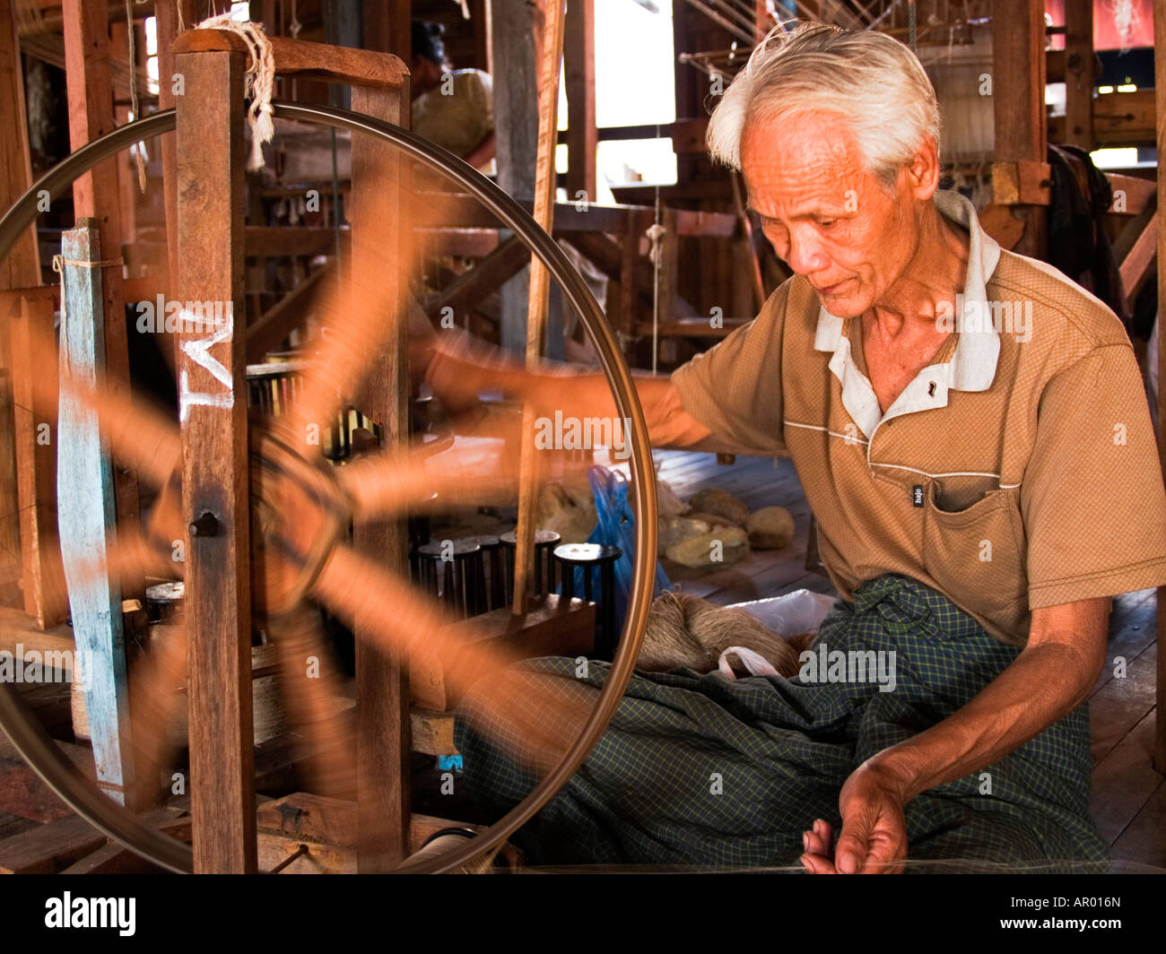 man spinning lotus threads into silk at Inle Lake in Myanmar Stock ...
