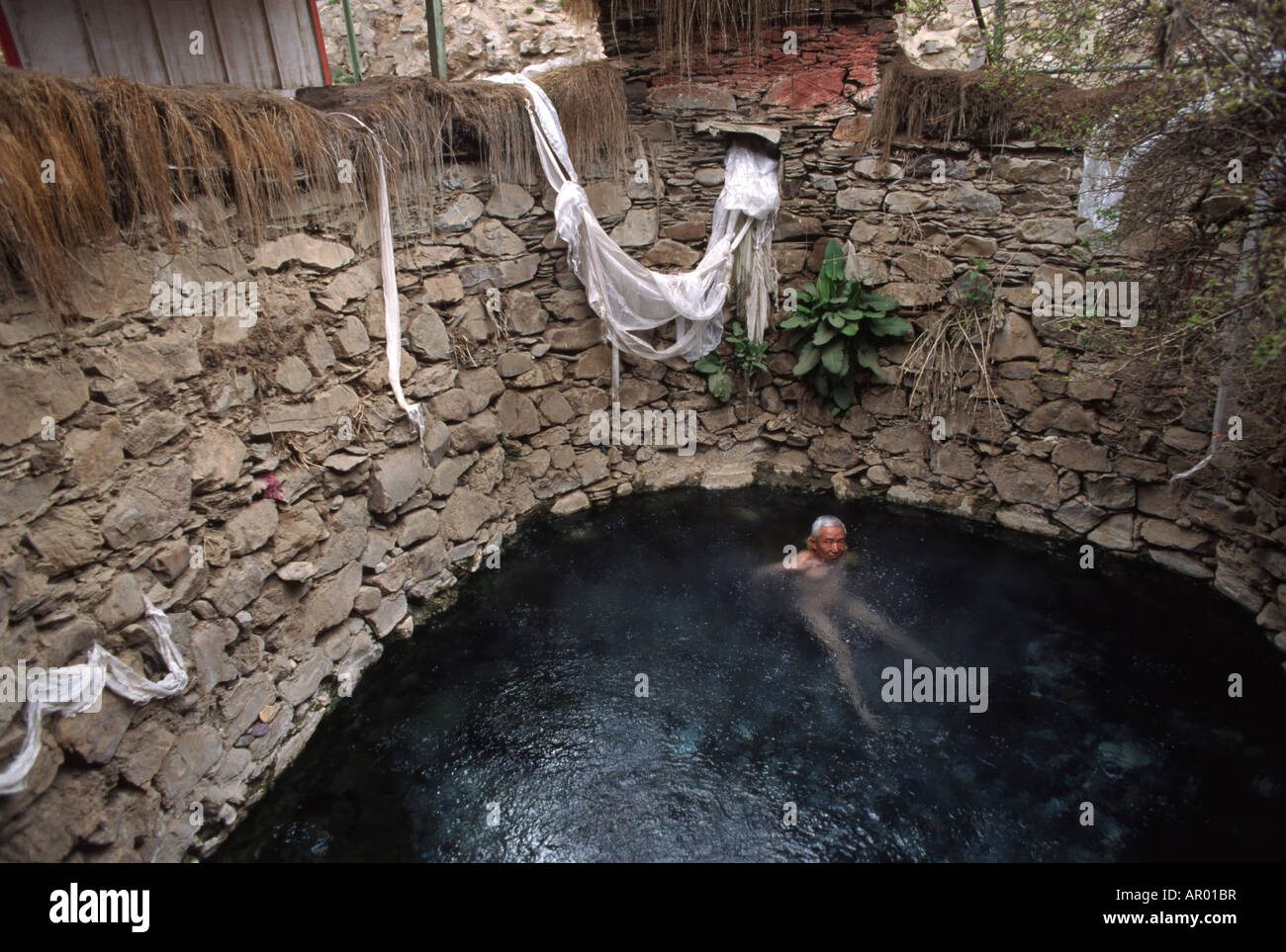 A pilgrim relaxes in the natural hot springs at TERDROM NUNNERY started ...