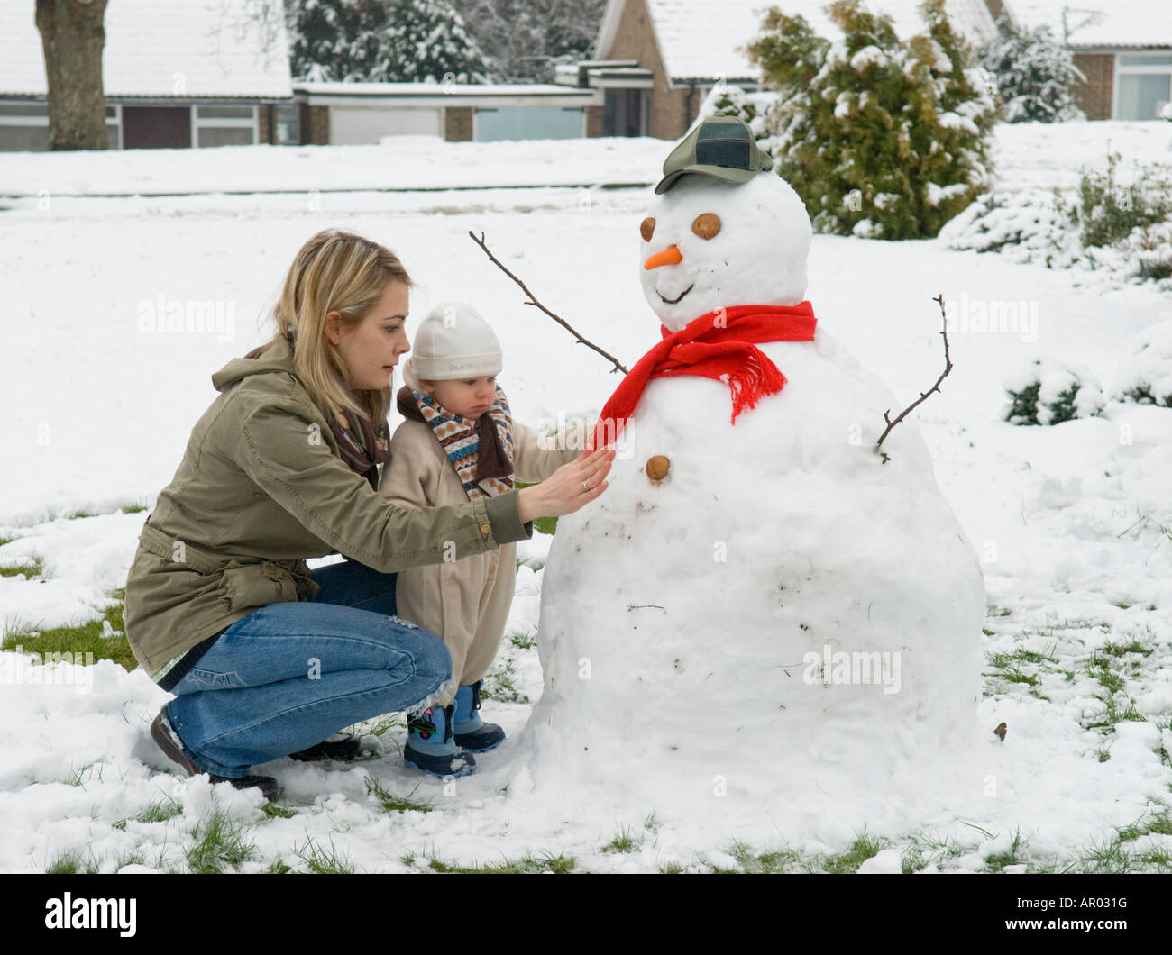 Boy making snowman in hi-res stock photography and images - Alamy
